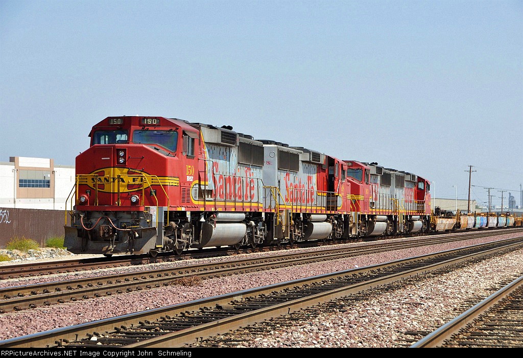BNSF 150 (ex ATSF GP60M) leads a lashup of red and silver GP60M's on an empty intermodal train ...